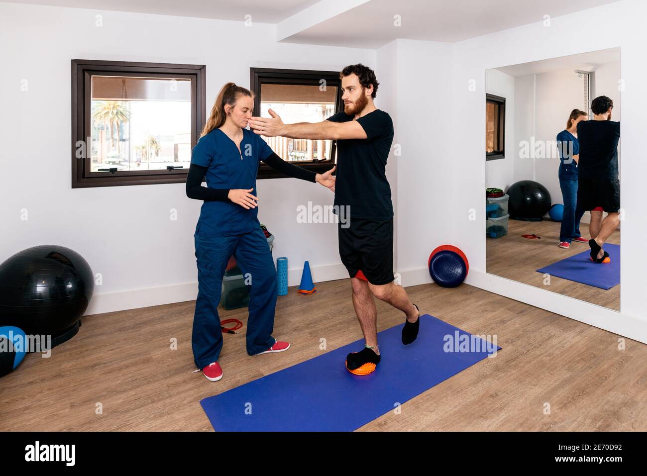 Stock photo of a man receiving help by physiotherapist professional ...