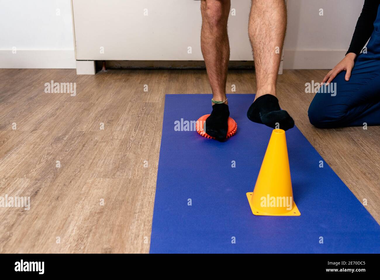 Stock photo of a man practicing with a cone in a physiotherapy clinic ...