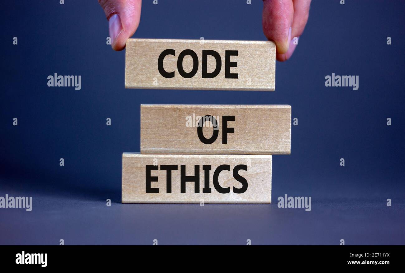 Code of ethics symbol. Wooden blocks with words 'Code of ethics ...