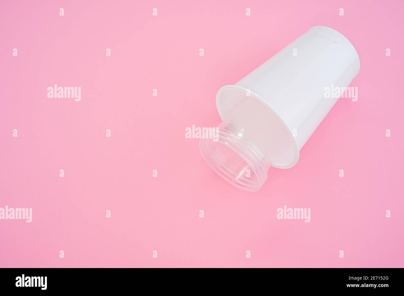 High angle shot of big and small plastic cups on a pink surface Stock ...