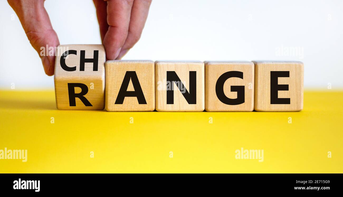 Change range symbol. Businessman turns a cube and changes the word ...