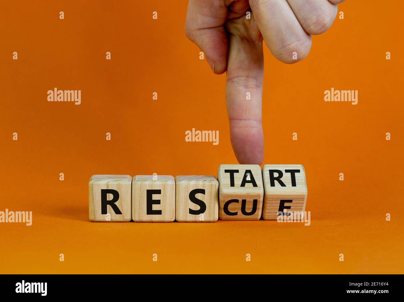 Rescue and restart symbol. Businessman hand turns cubes and changes the ...