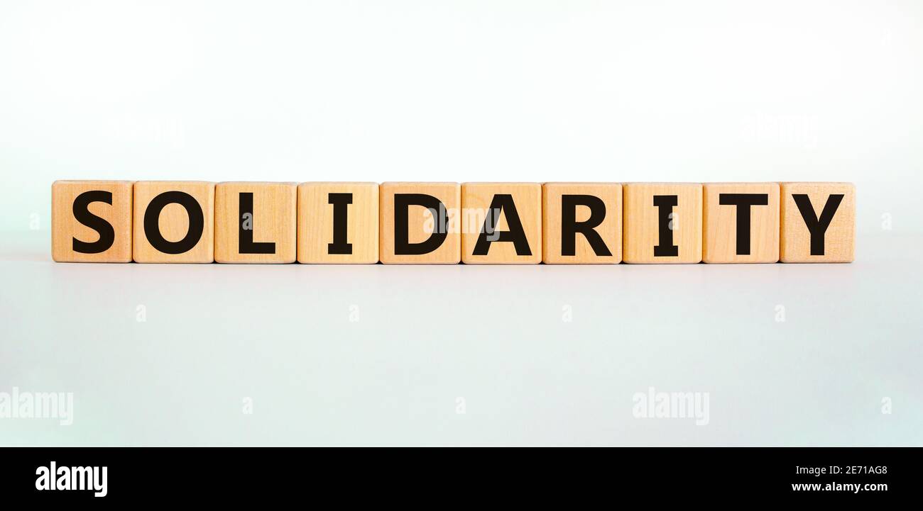 Time to solidarity symbol. Concept word solidarity on wooden cubes on a ...