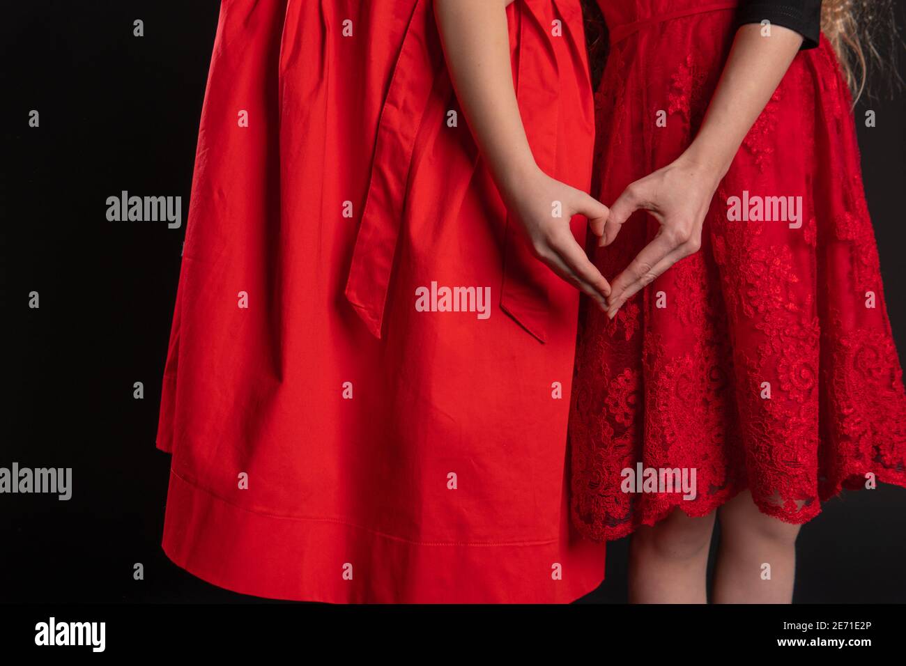 Girl and baby sign love hands hold a valentine's background, flirting ...