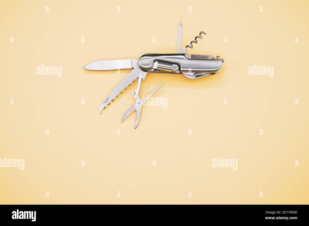 High angle shot of a swiss army knife on a yellow surfac Stock Photo ...