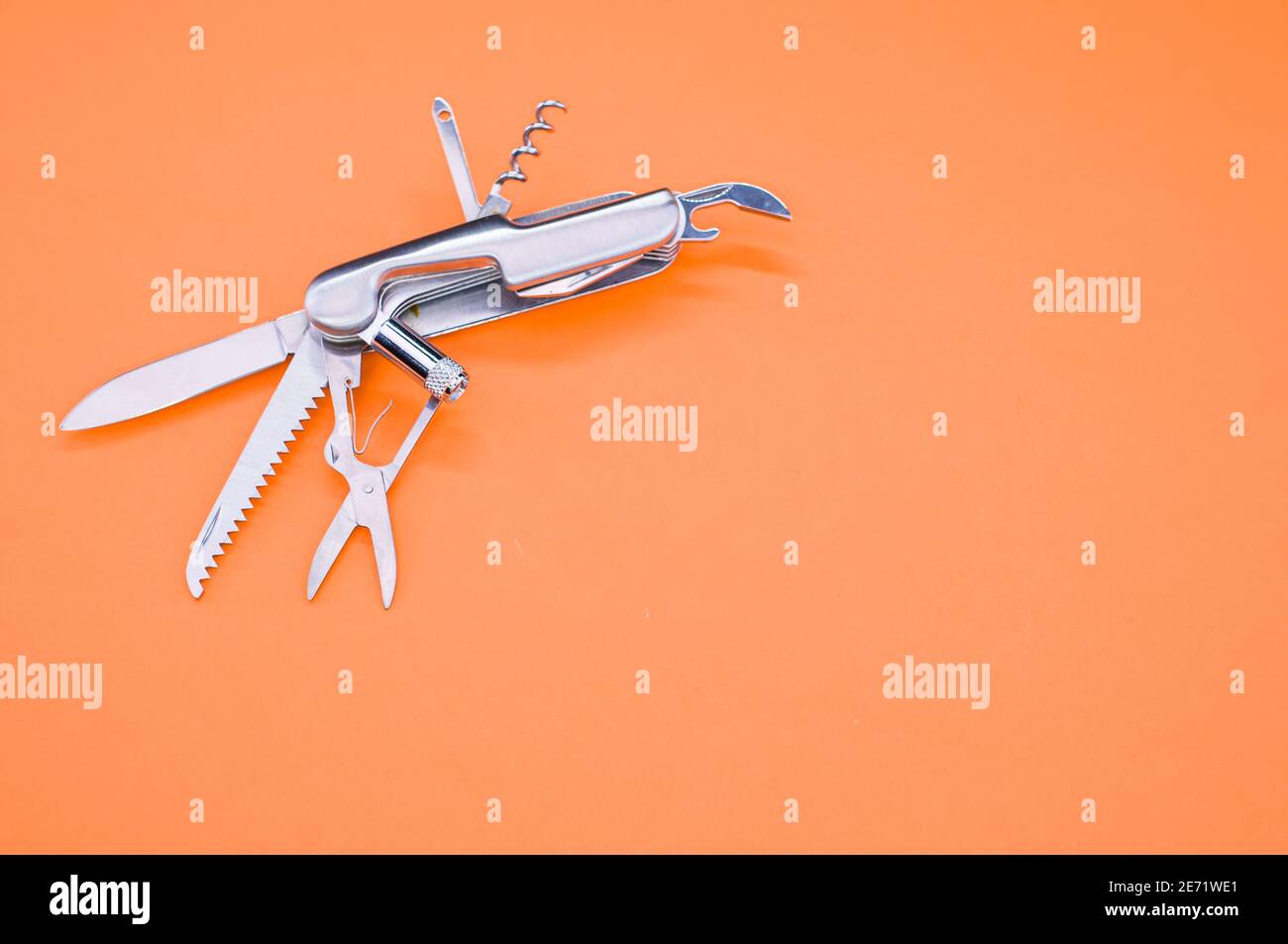 High angle shot of a swiss army knife on an orange surface Stock Photo ...