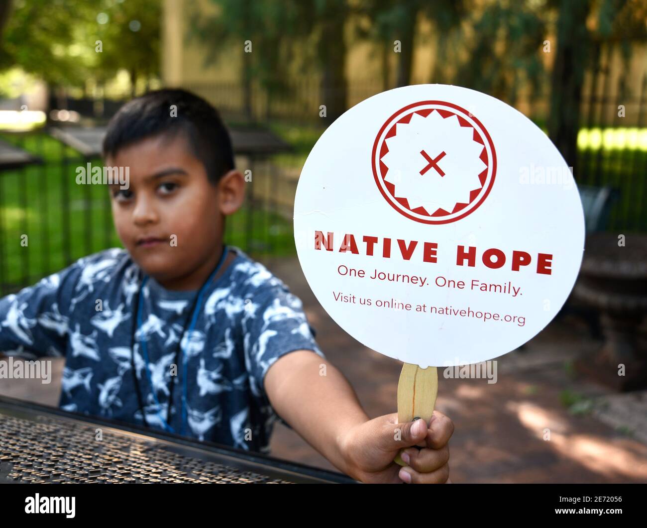 A young Native-American boy holds a fan distributed by the Native Hope ...