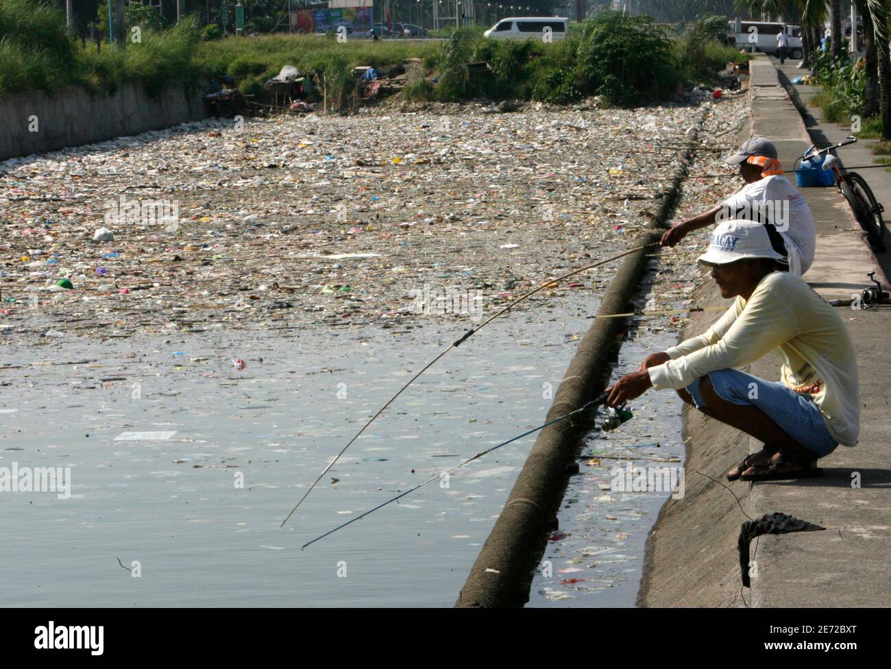 Man fishing in polluted water hi-res stock photography and images - Alamy