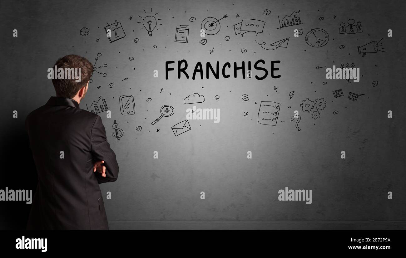 businessman drawing a creative idea sketch with FRANCHISE inscription ...
