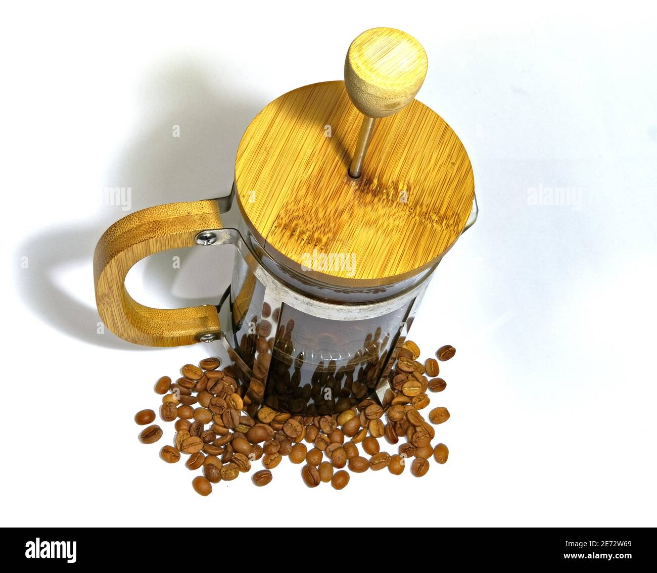 French press coffee maker on the white ground. Arabic coffee beans ...