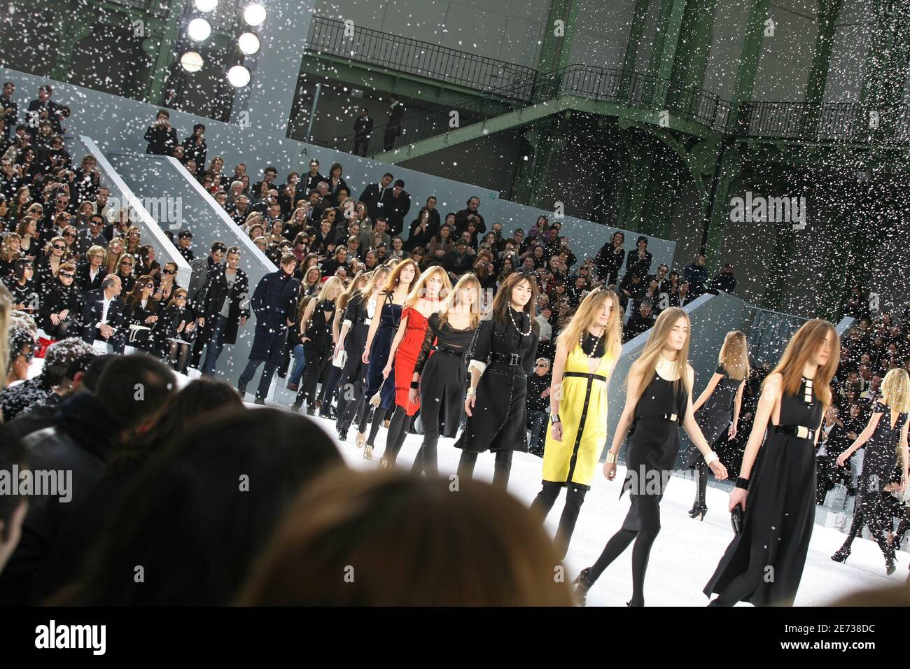 Models hit the catwalk under fake snow during the Chanel Fall-Winter ...