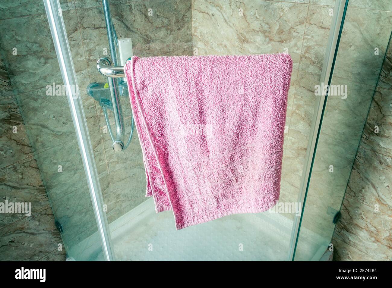 Pink towel in the shower room Stock Photo - Alamy