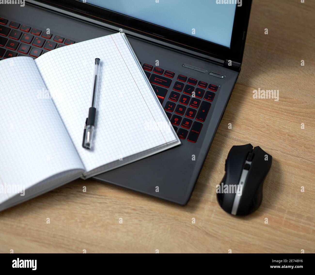 Laptop with wireless mouse, notebook and pen on the office table Stock ...