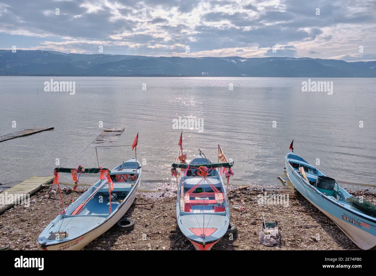 Small and blue boats near the coast of Lake of Uluabat in Turkey. Small ...
