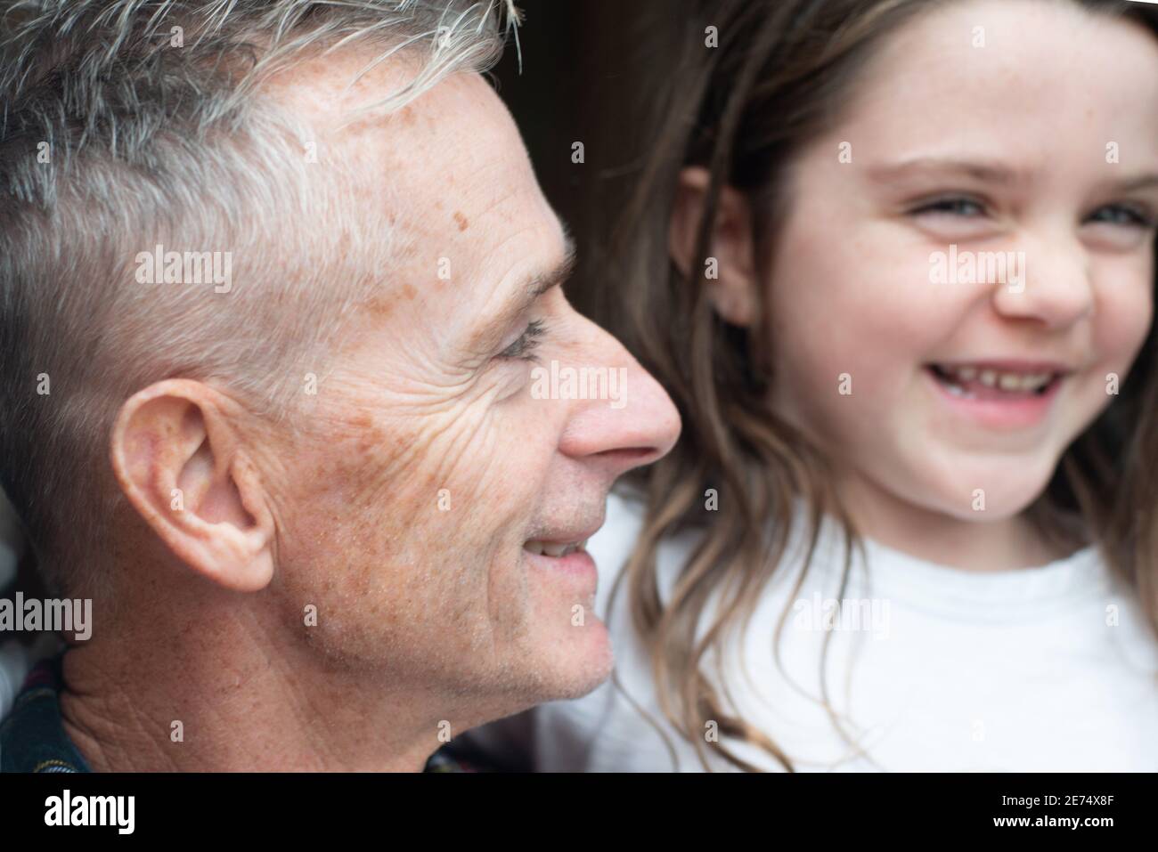 caucasian middle aged father looking adoringly at daughter Stock Photo ...