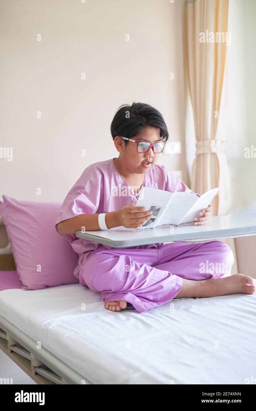 The boy patient was resting by reading health pamphlets Stock Photo - Alamy