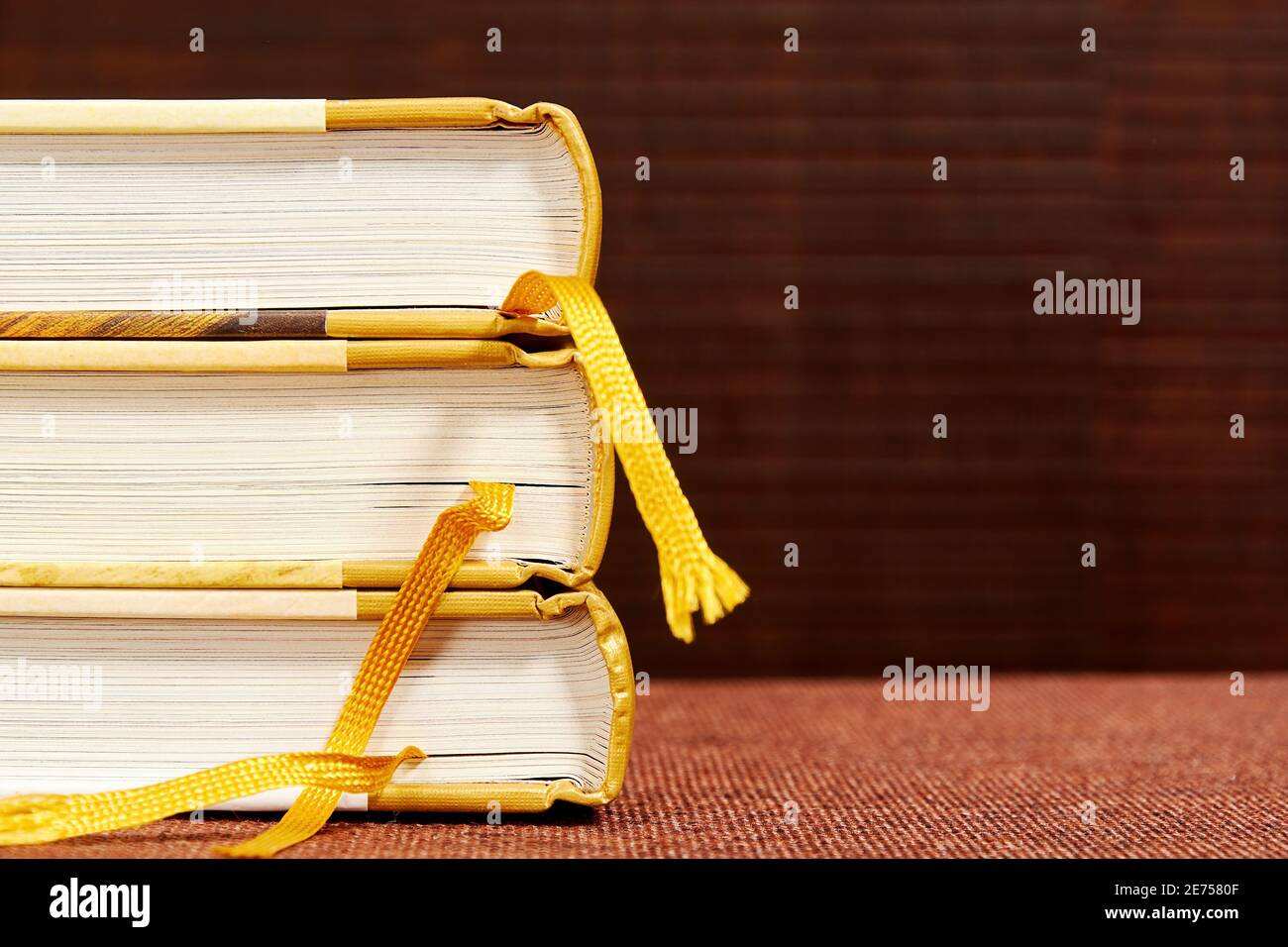 Stack of yellow hardcovered books with bookmarks with a novel on a ...