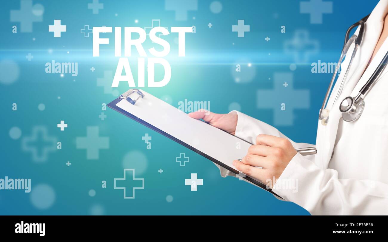 doctor writes notes on the clipboard with FIRST AID inscription, first ...