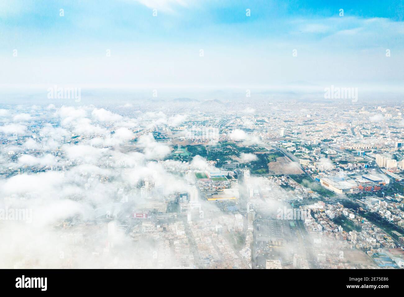 Aerial view of Lima between the clouds, view flying over the tops of ...