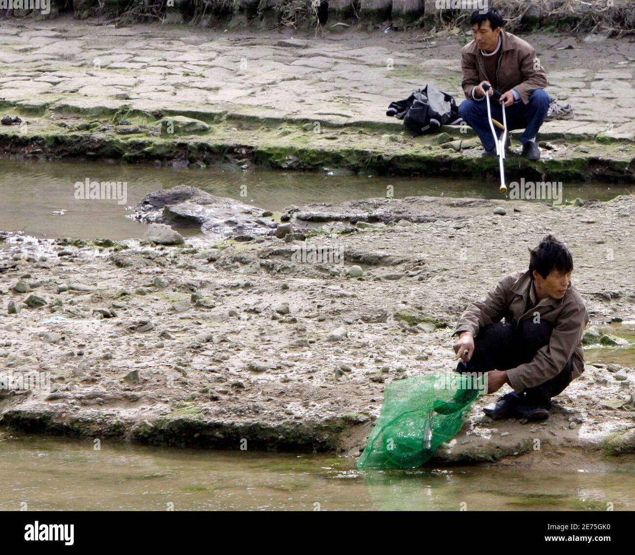 Man fishing in polluted water hi-res stock photography and images - Alamy