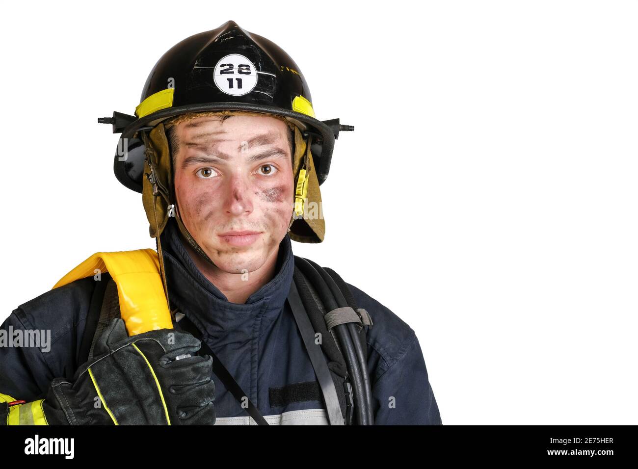 Close-up face of young brave man in uniform and hardhat of firefighter ...