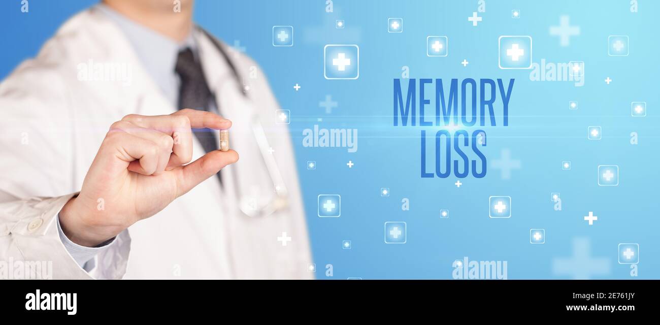 Close-up of a doctor giving a pill with MEMORY LOSS inscription ...