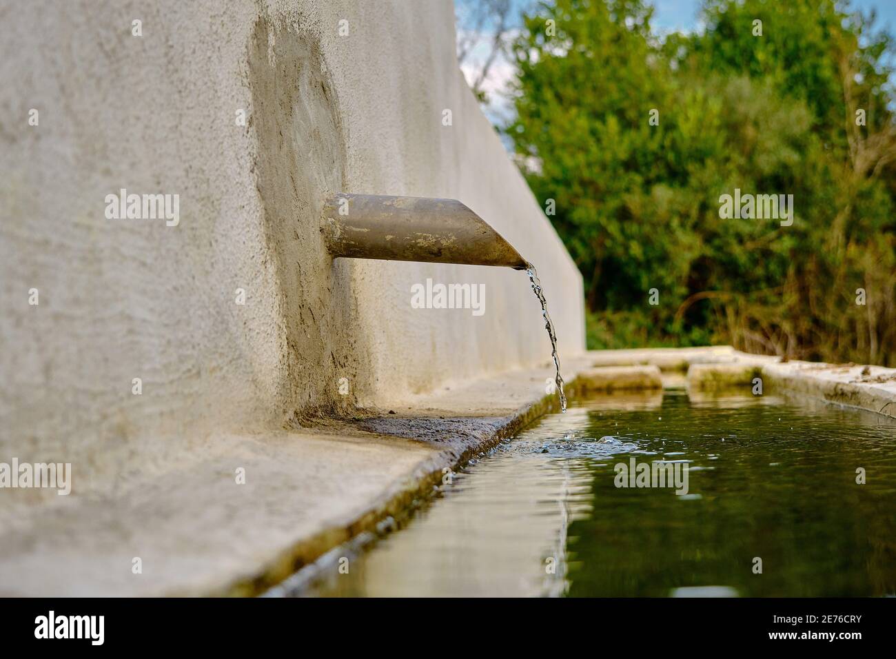 Spring and natural drinkable water and fountain outside near the gravel ...