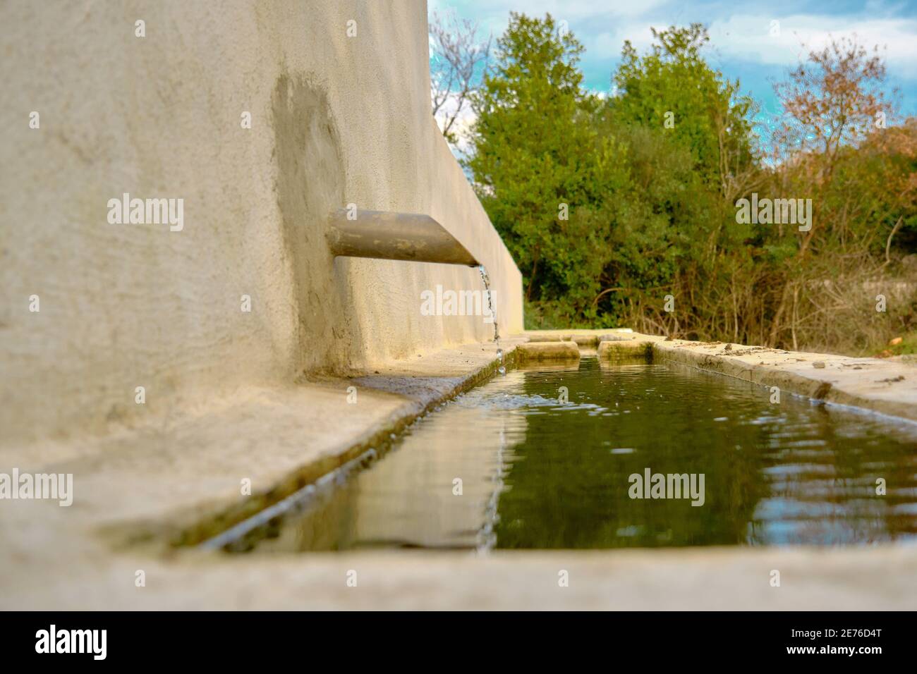 Spring and natural drinkable water and fountain outside near the gravel ...