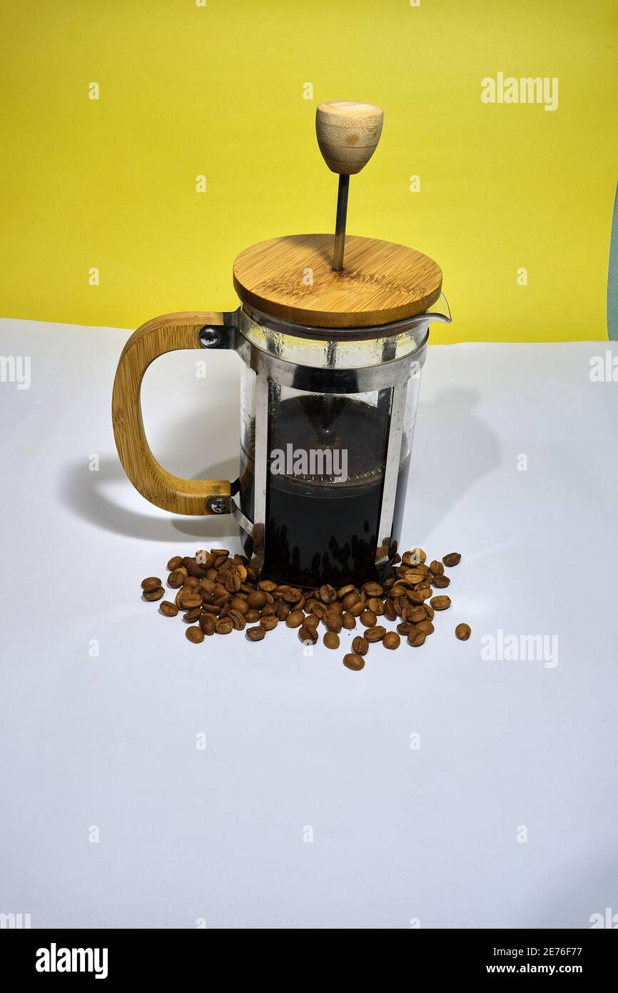 french press and cooked caffe inside the glass side of the press and ...
