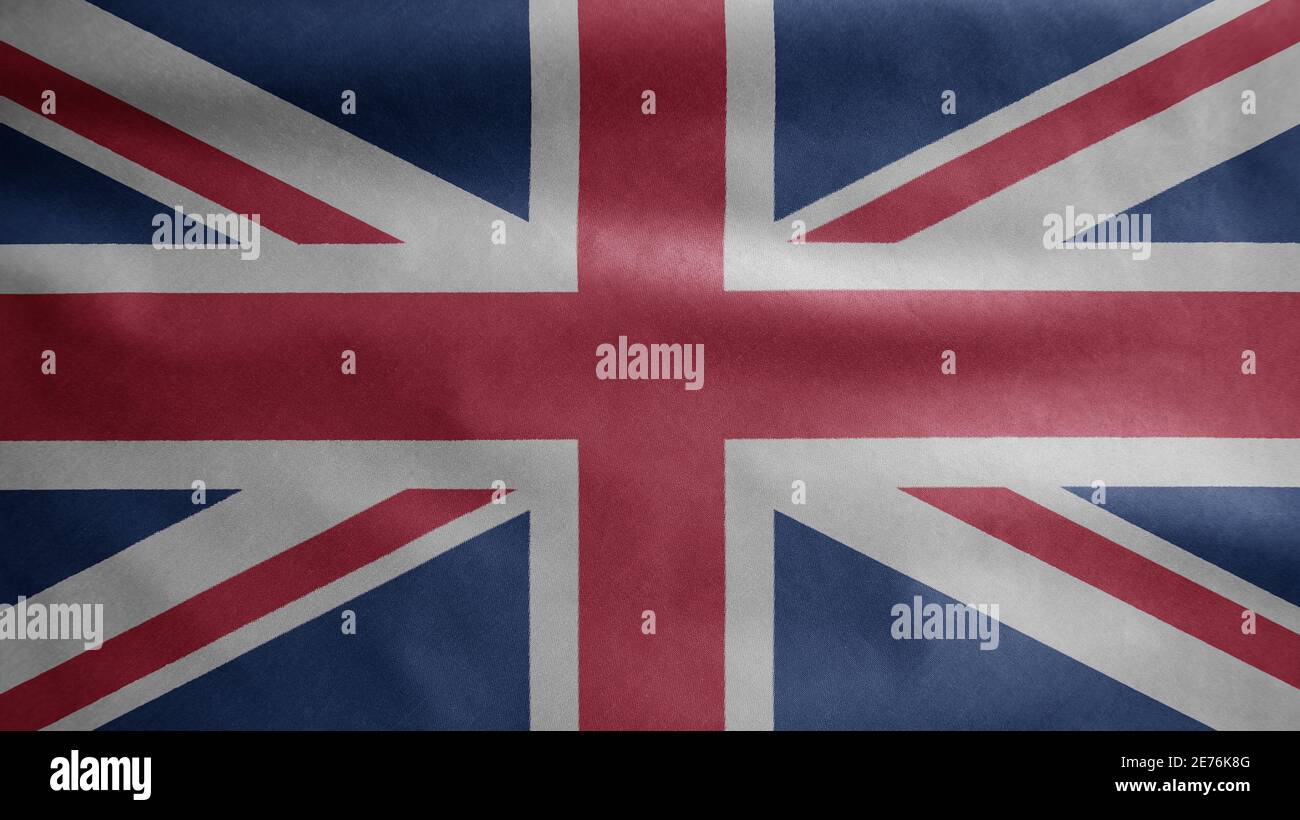 United Kingdom flag waving in the wind. Close up of Britain banner ...