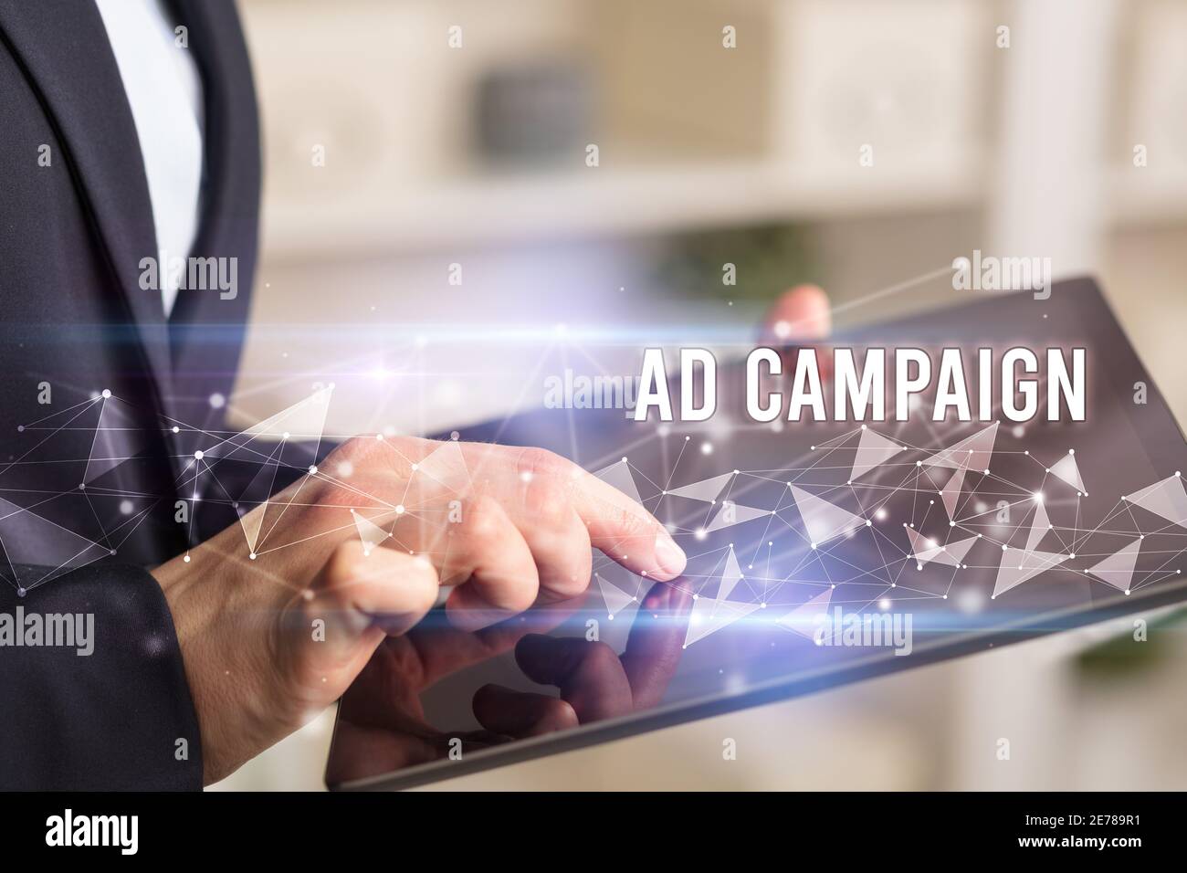 Close up hands using tablet with AD CAMPAIGN inscription, modern ...