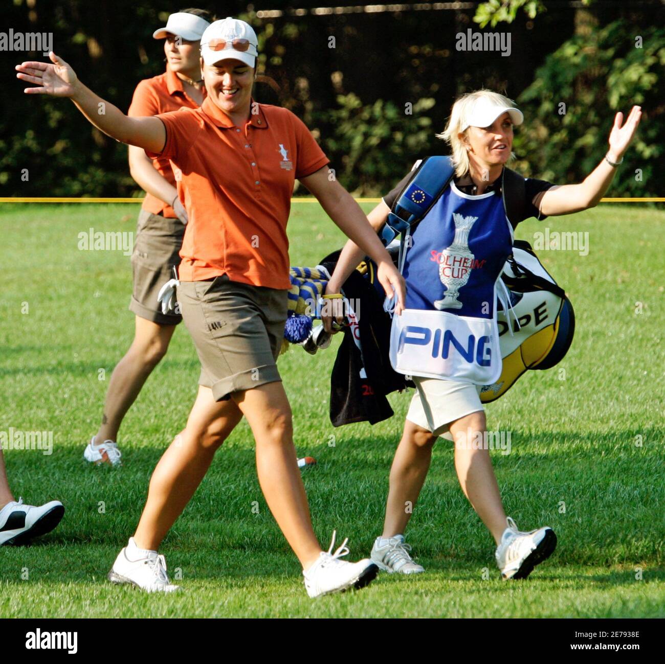 Golfer walking with caddie hi-res stock photography and images - Alamy
