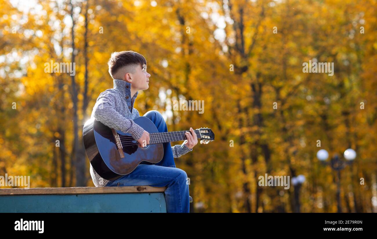 Boy playing musical instruments hi-res stock photography and images - Alamy