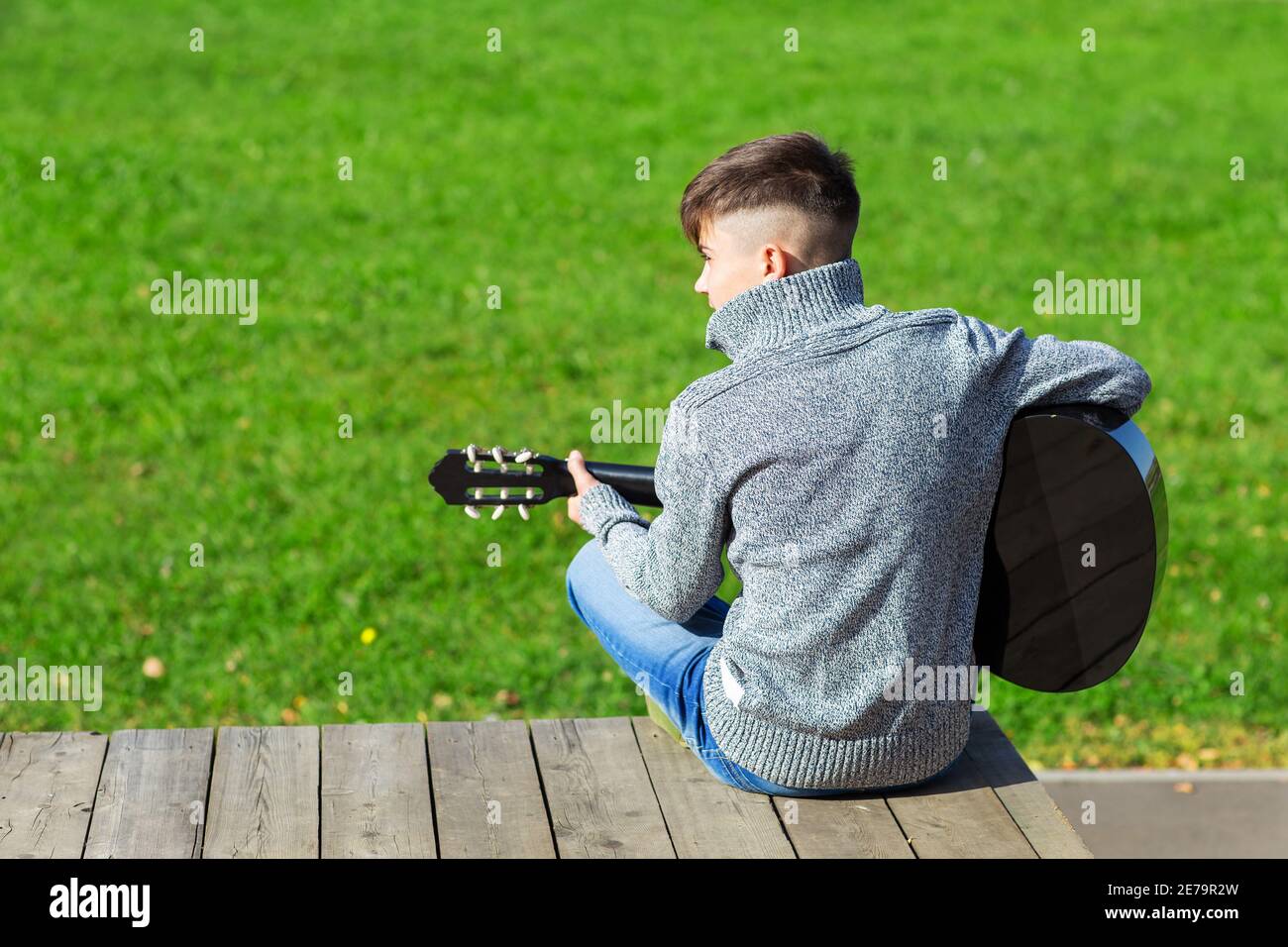 Boy playing musical instruments hi-res stock photography and images - Alamy