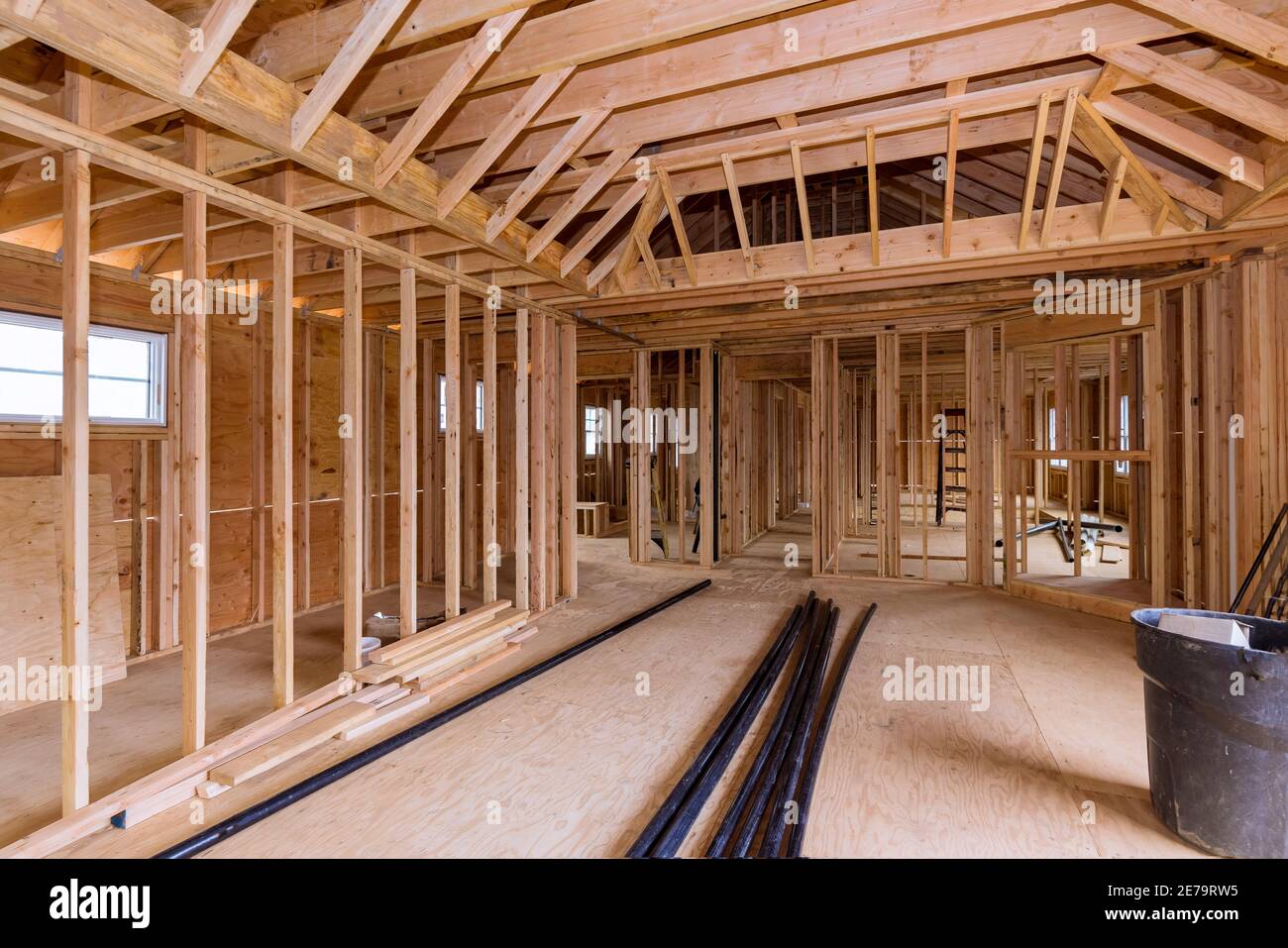 Wooden under construction new residential home beam framing and PVC ...