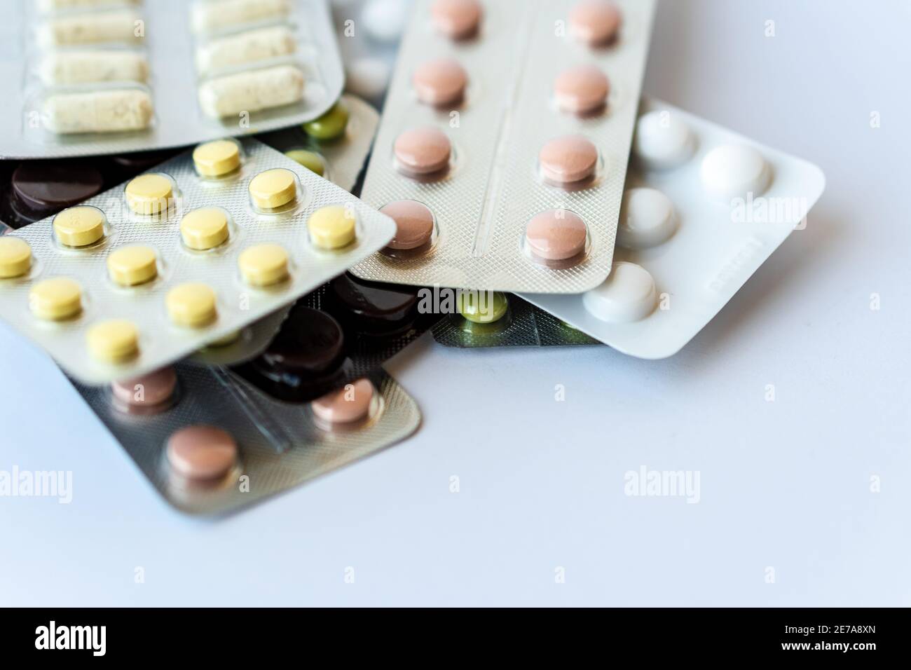 Medicine and pills. Multi-colored medicines on a white background close ...