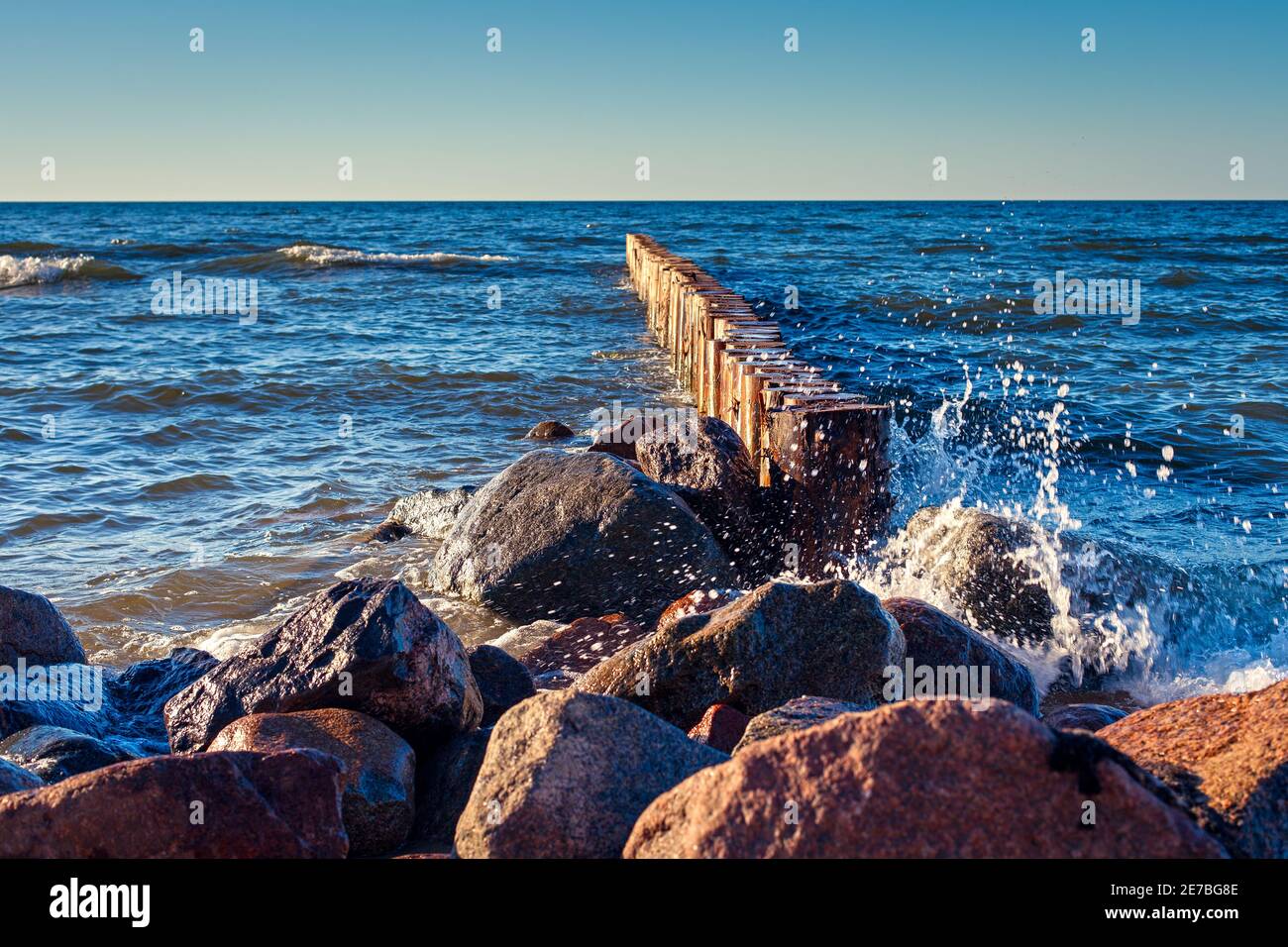 Baltic Sea at sunset, groins and rocks Stock Photo - Alamy