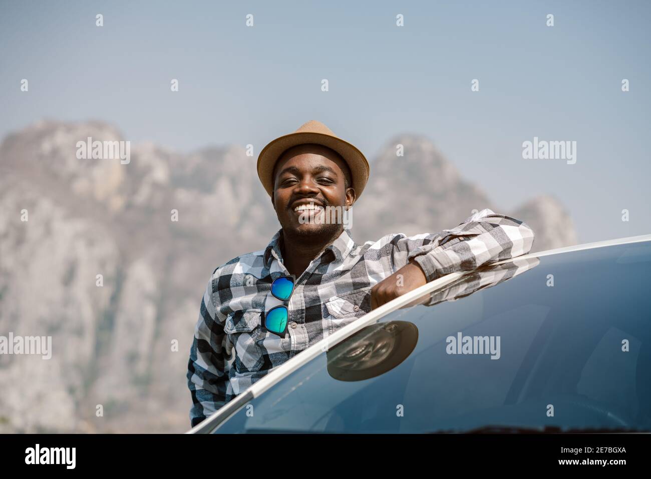 African traveler man standing with car on to the mountains Stock Photo ...