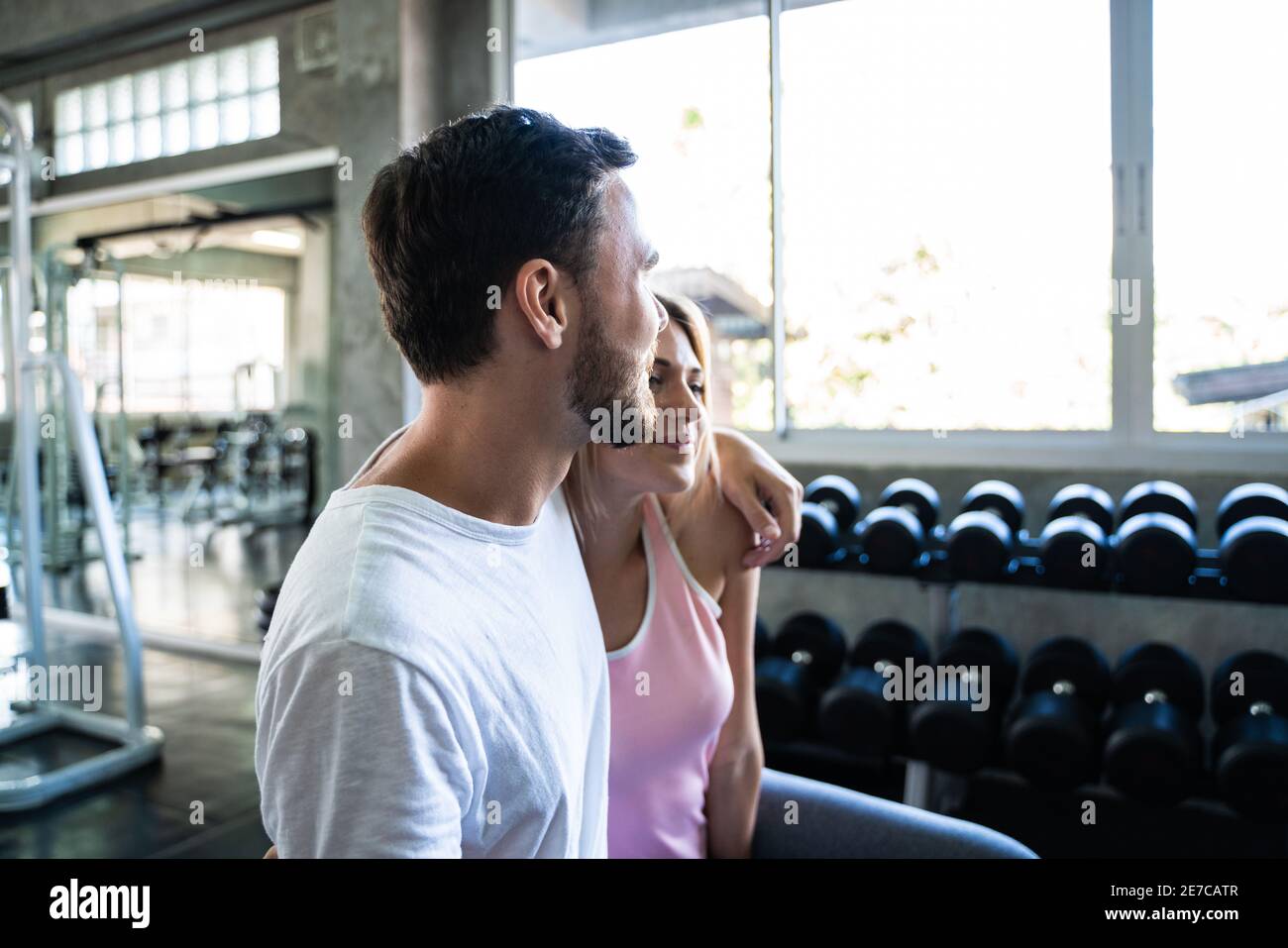 Muscular couple practice and talking in fitness gym healthy lifestyle ...
