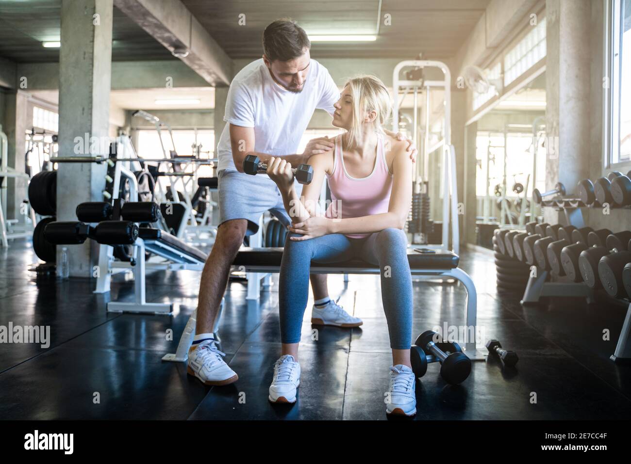 Muscular couple practice and talking in fitness gym healthy lifestyle ...