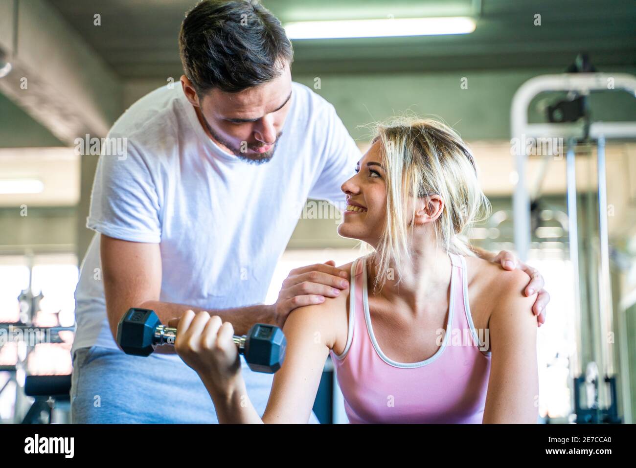 Muscular couple practice and talking in fitness gym healthy lifestyle ...