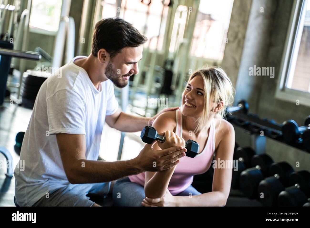 Muscular couple practice and talking in fitness gym healthy lifestyle ...
