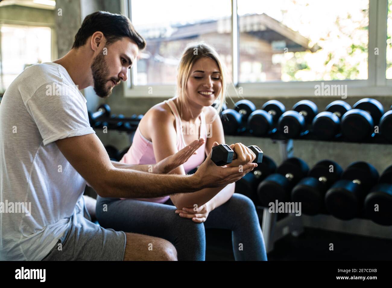 Muscular couple practice and talking in fitness gym healthy lifestyle ...