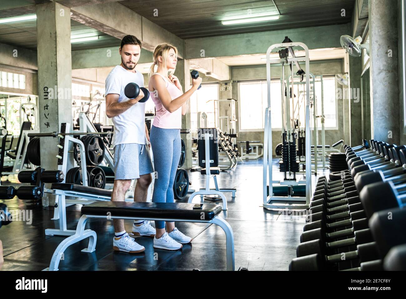 Muscular couple practice and talking in fitness gym healthy lifestyle ...