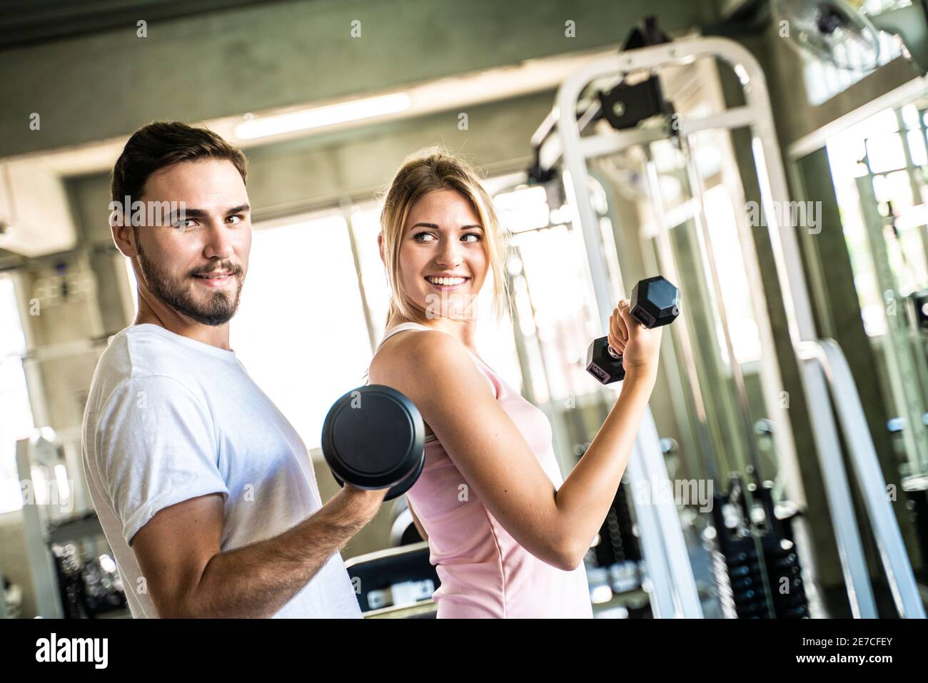 Muscular couple practice and talking in fitness gym healthy lifestyle ...