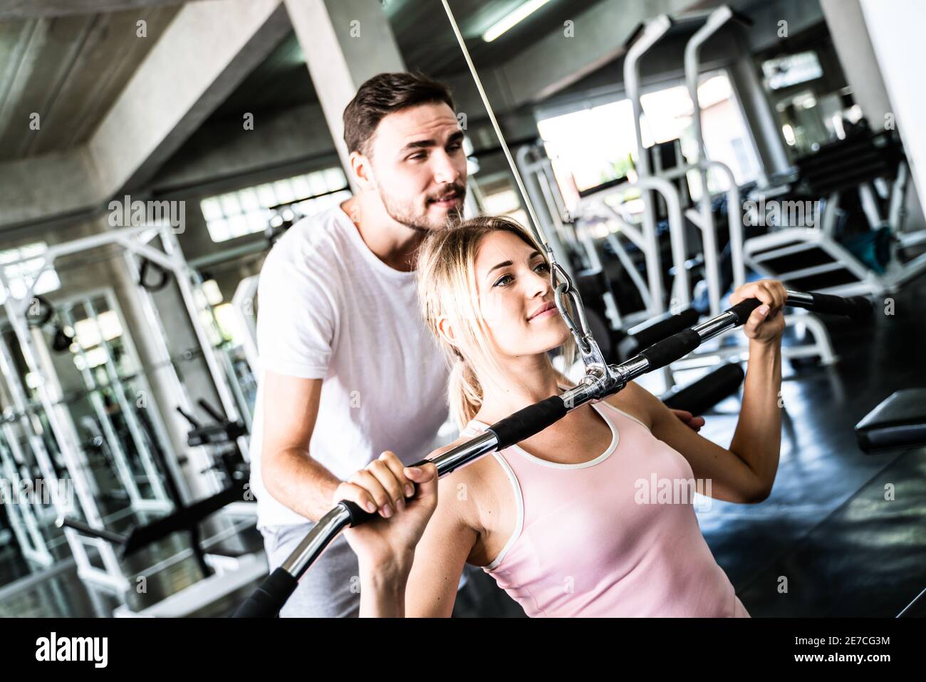 Muscular couple practice and talking in fitness gym healthy lifestyle ...