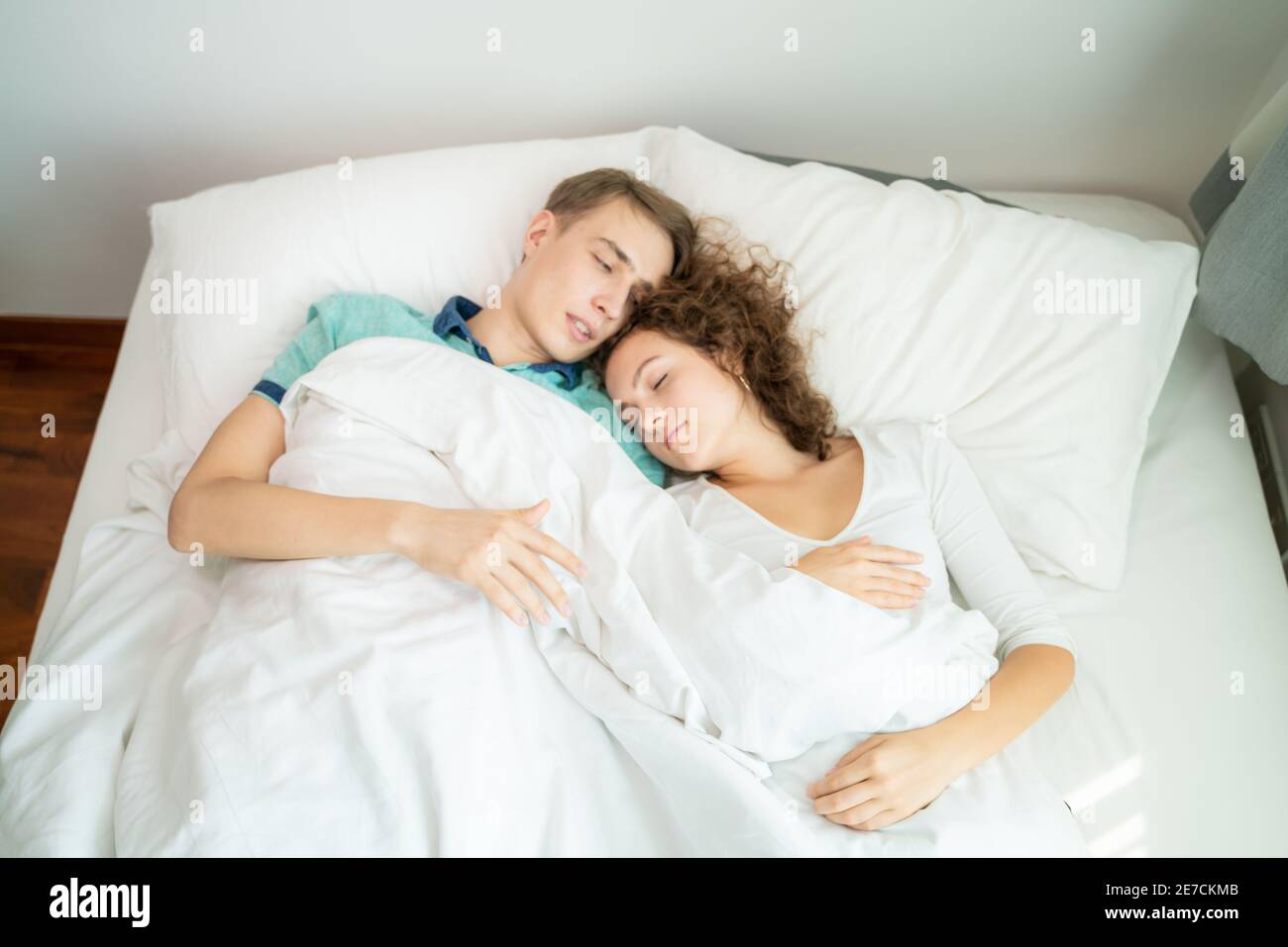 Happy caucasian couple sleeping relax on white bed romantic of love ...