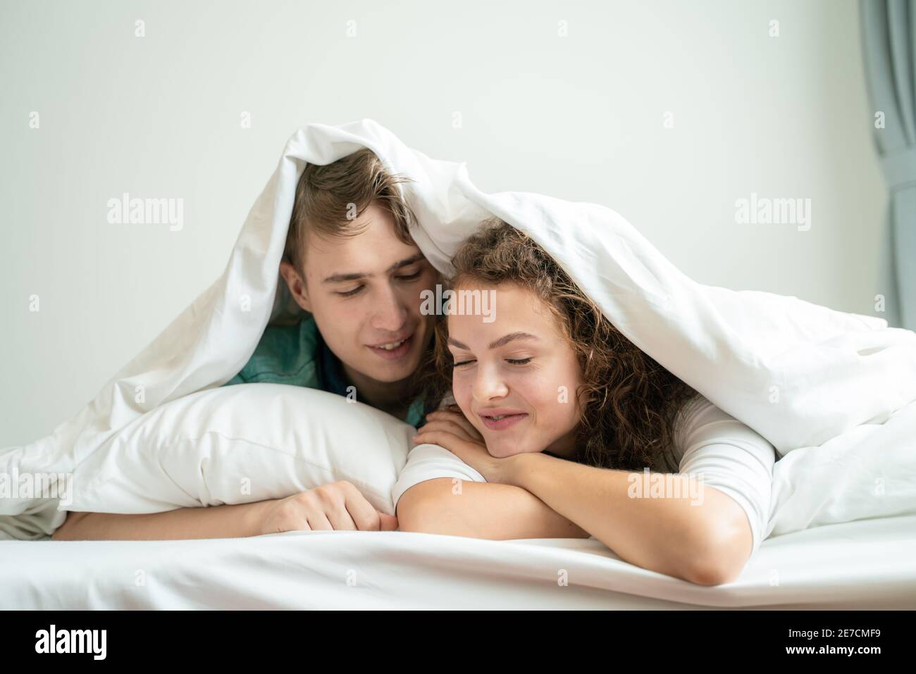 Happy caucasian couple sleeping relax on white bed romantic of love ...