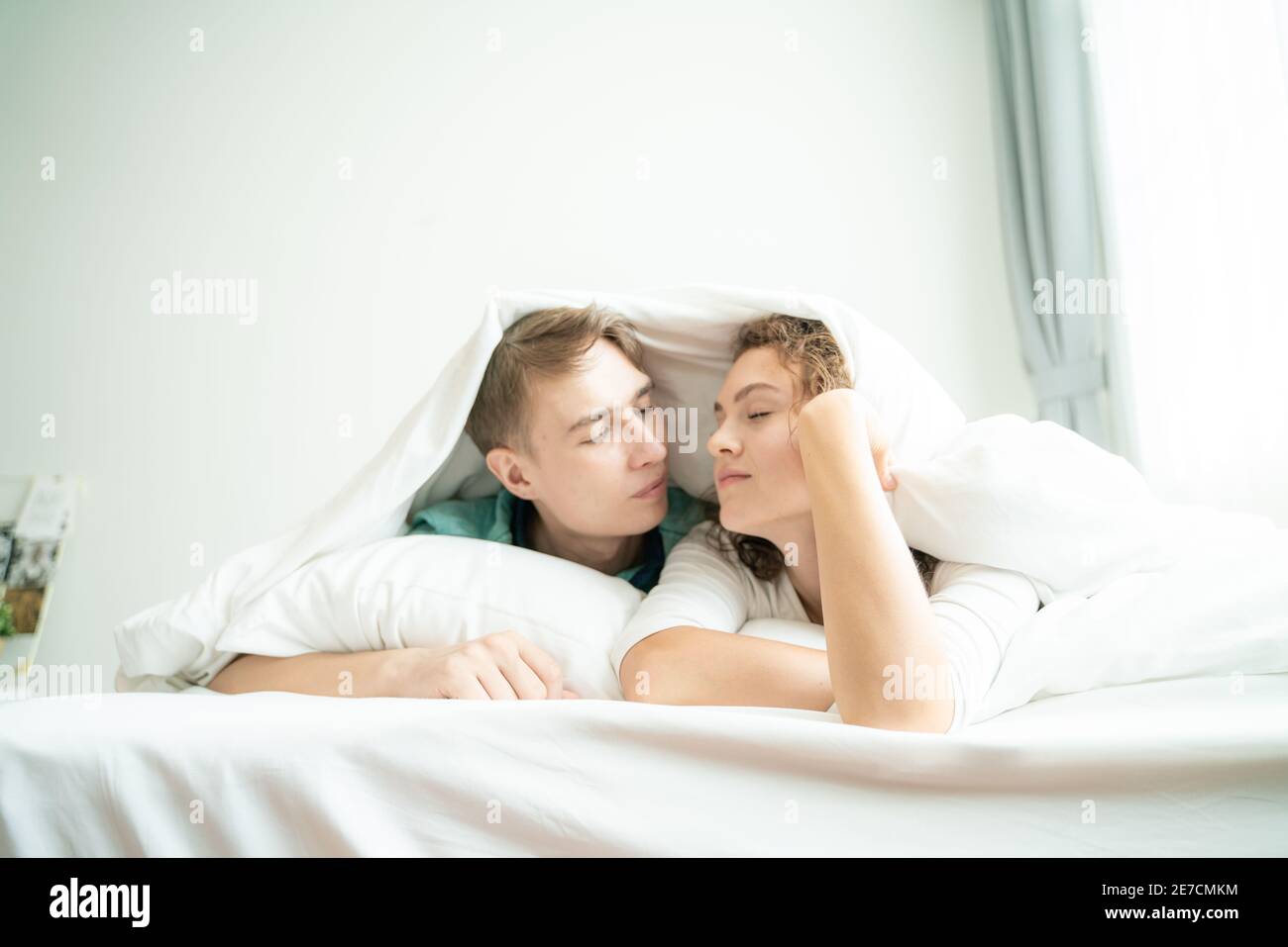 Happy caucasian couple sleeping relax on white bed romantic of love ...