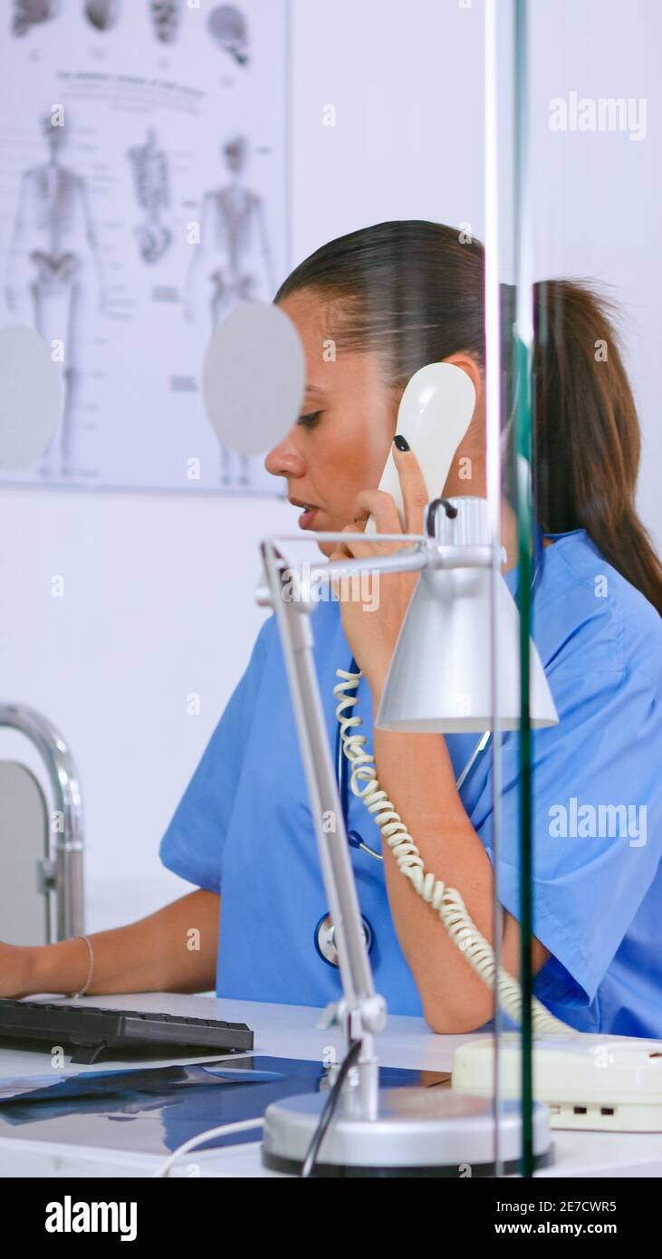 Healthcare physician answering phone calls from patient in hospital ...